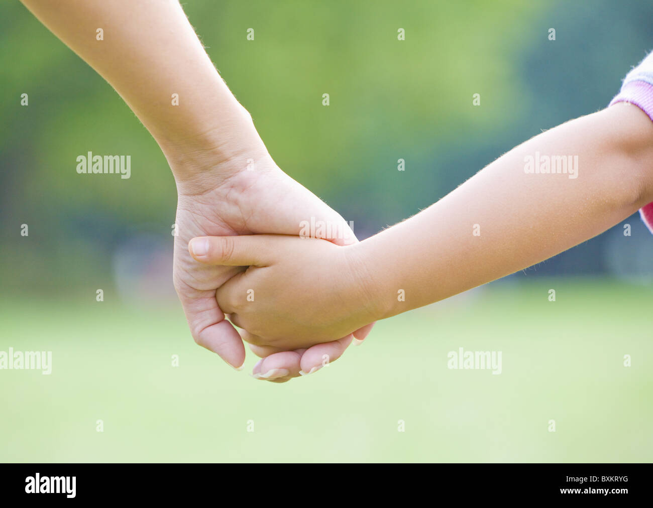 Parent and child holding hands Stock Photo - Alamy