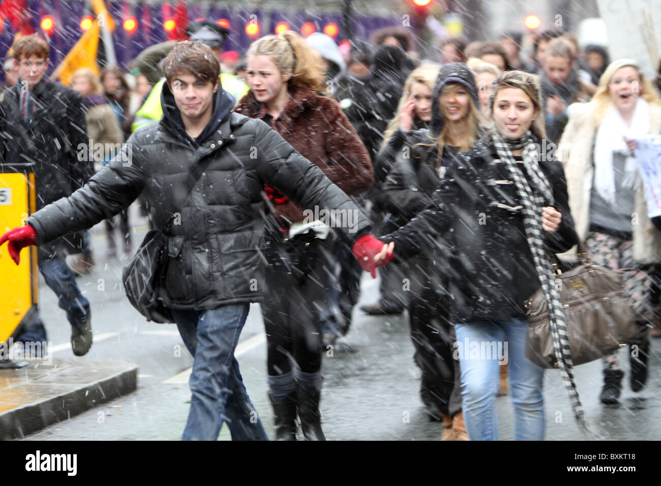 English Students' anti cuts protest through the snowy streets of London ...