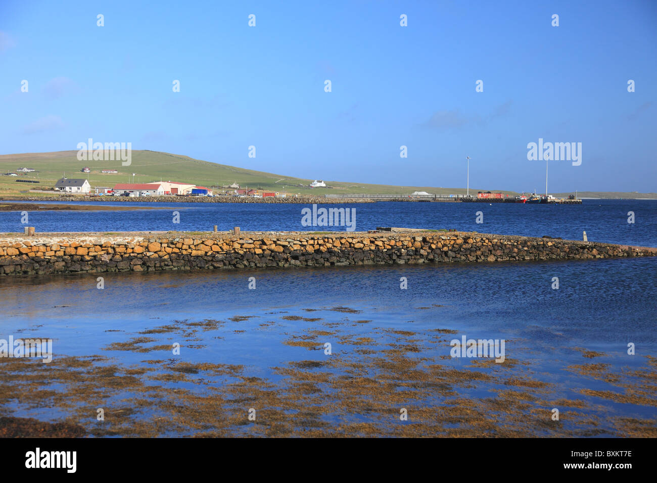 Sea wall of the small boat marina looking towards the main harbour at ...