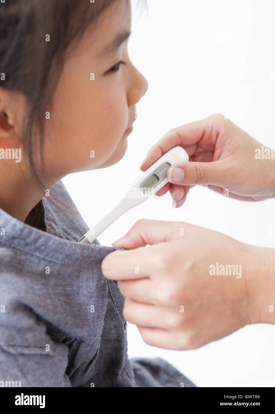 A girl checking her temperature Stock Photo - Alamy