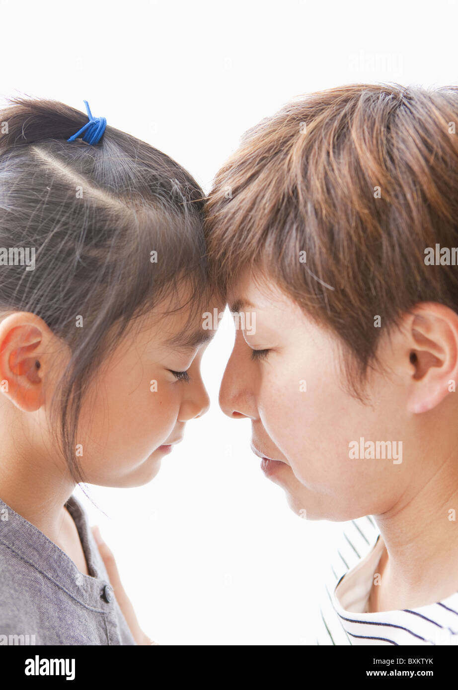 Mother and daughter putting thier foreheads together Stock Photo - Alamy