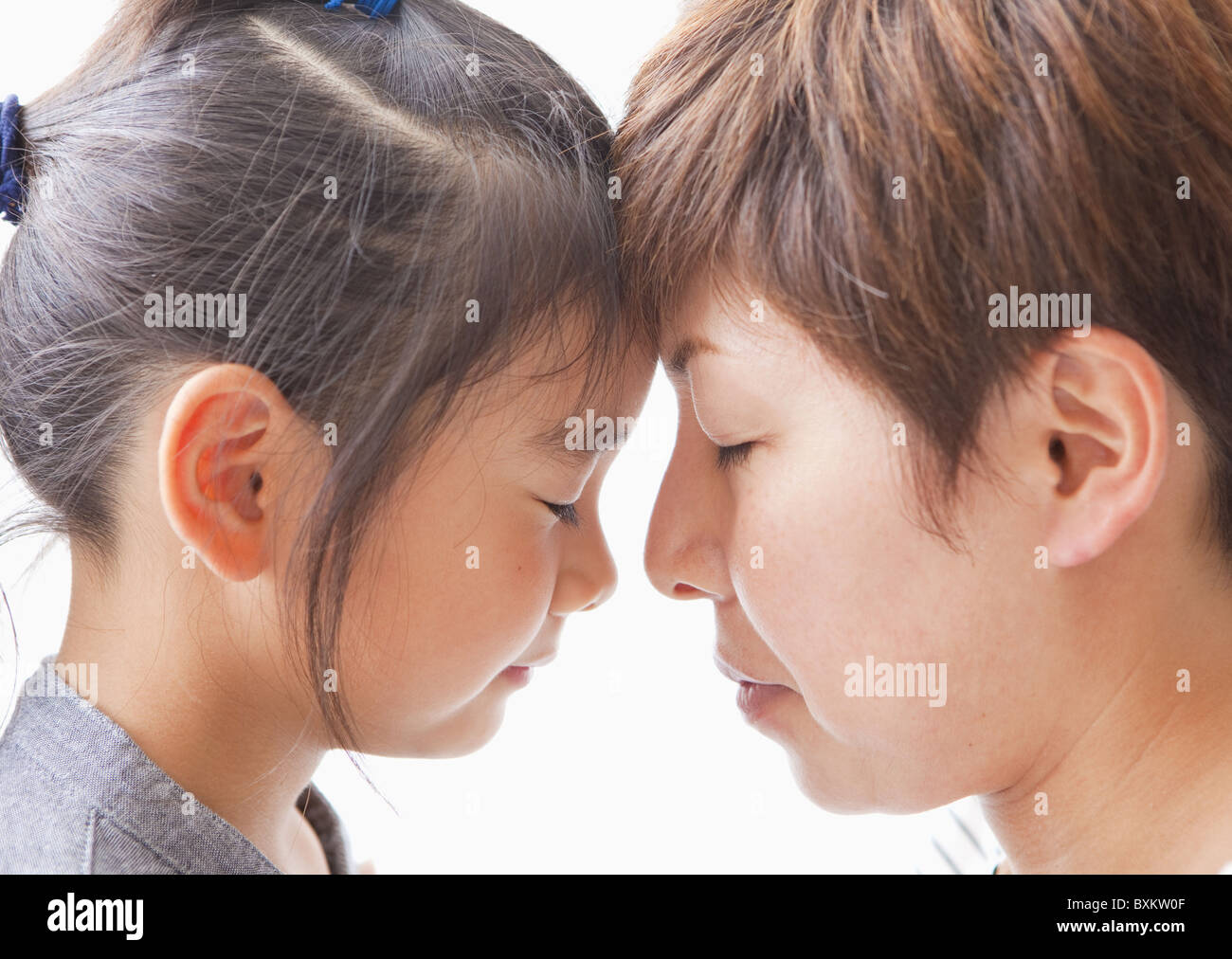 Mother and daughter putting thier foreheads together Stock Photo - Alamy