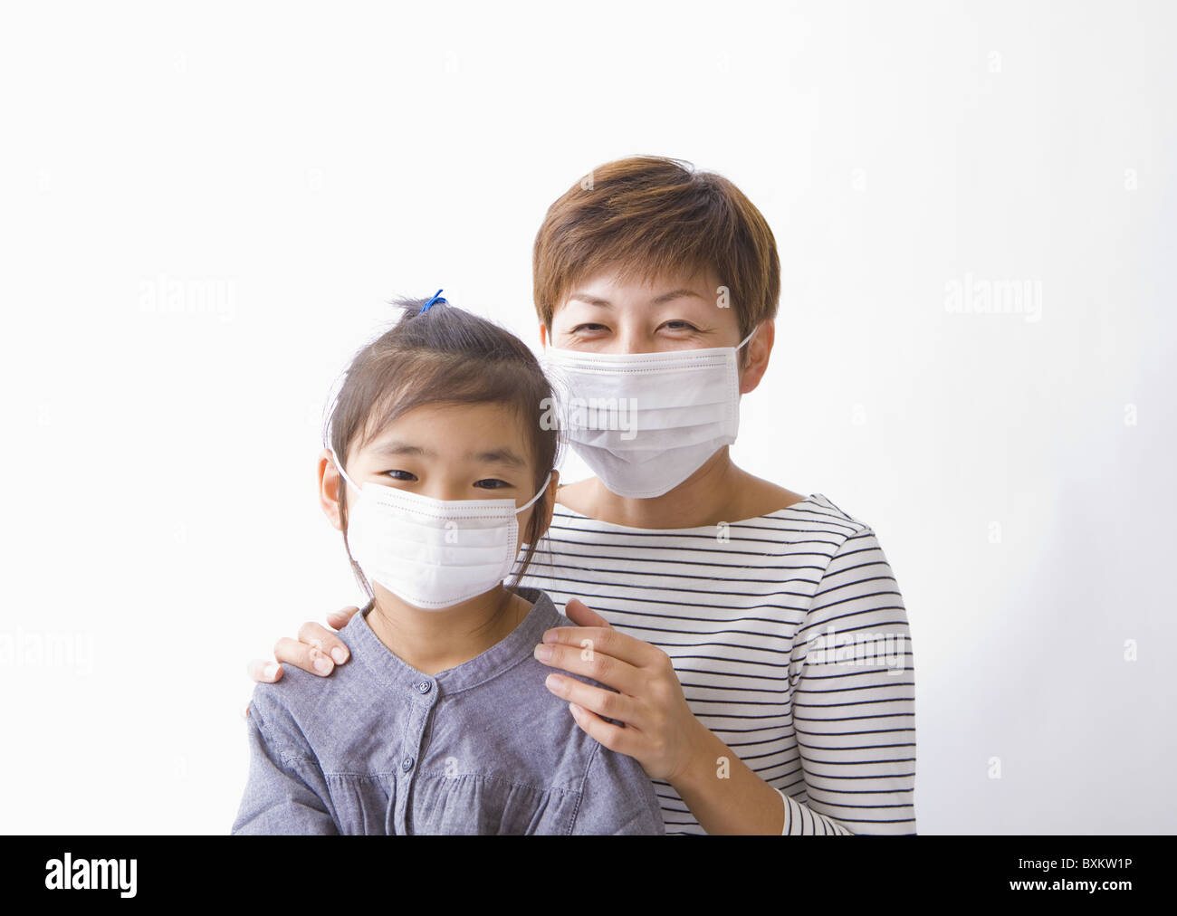 Mother and daughter wearing masks Stock Photo - Alamy