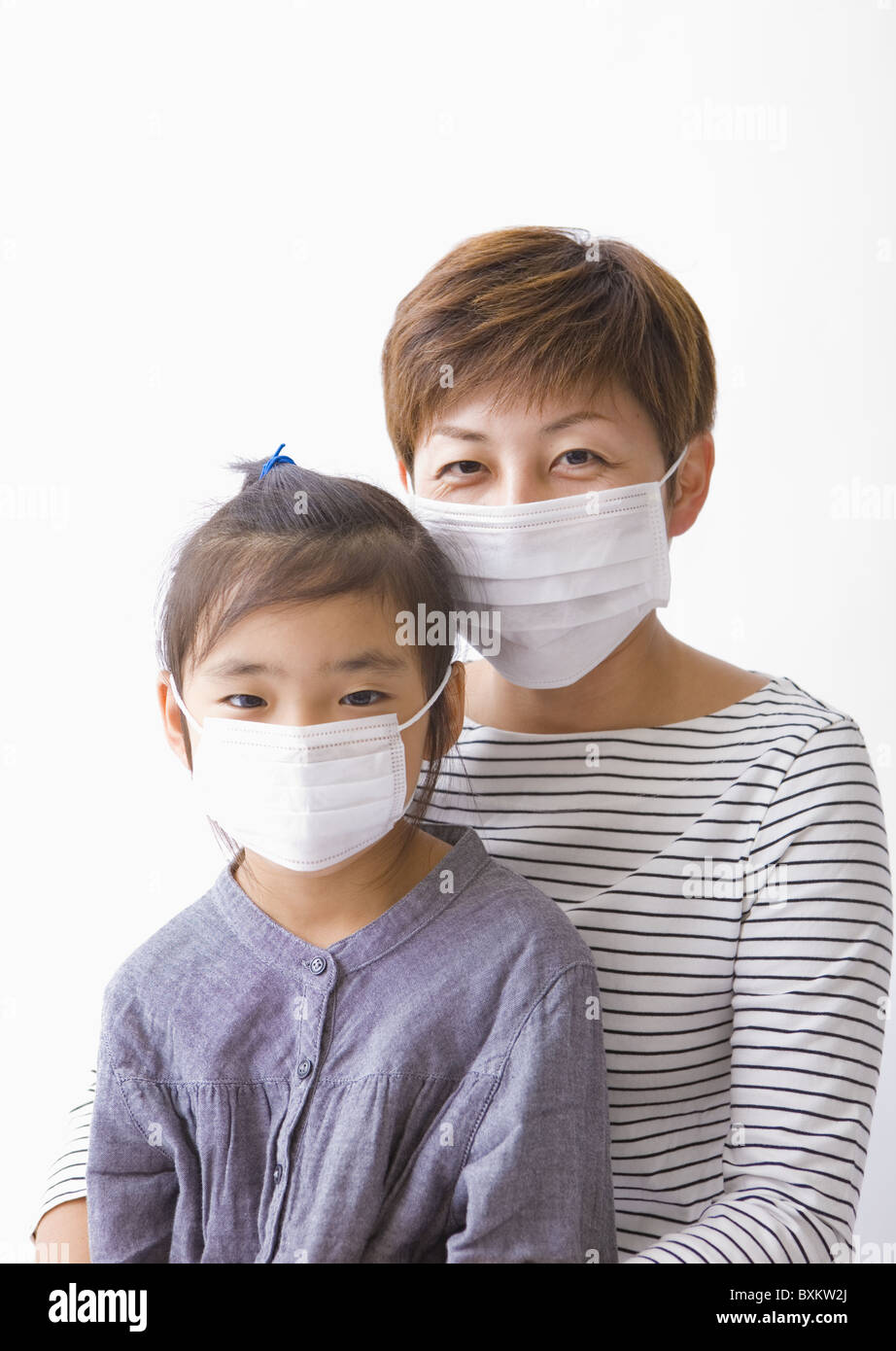Mother and daughter wearing masks Stock Photo - Alamy