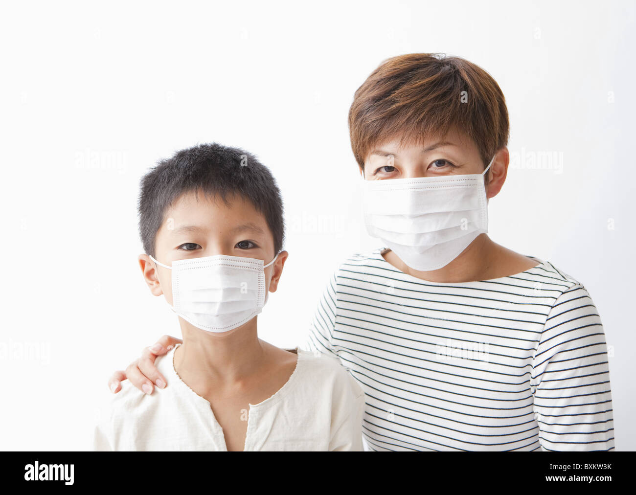 Mother and daughter wearing masks Stock Photo - Alamy
