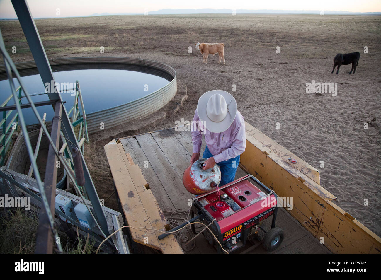 Rancher Fills Generator with Diesel Fuel to Pump Water for Cattle Stock ...