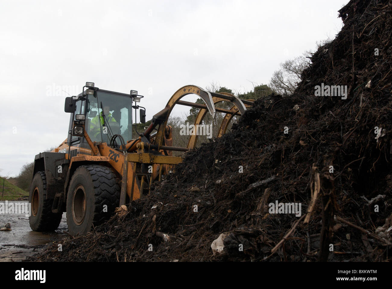 Front loader working at composting centre Stock Photo - Alamy