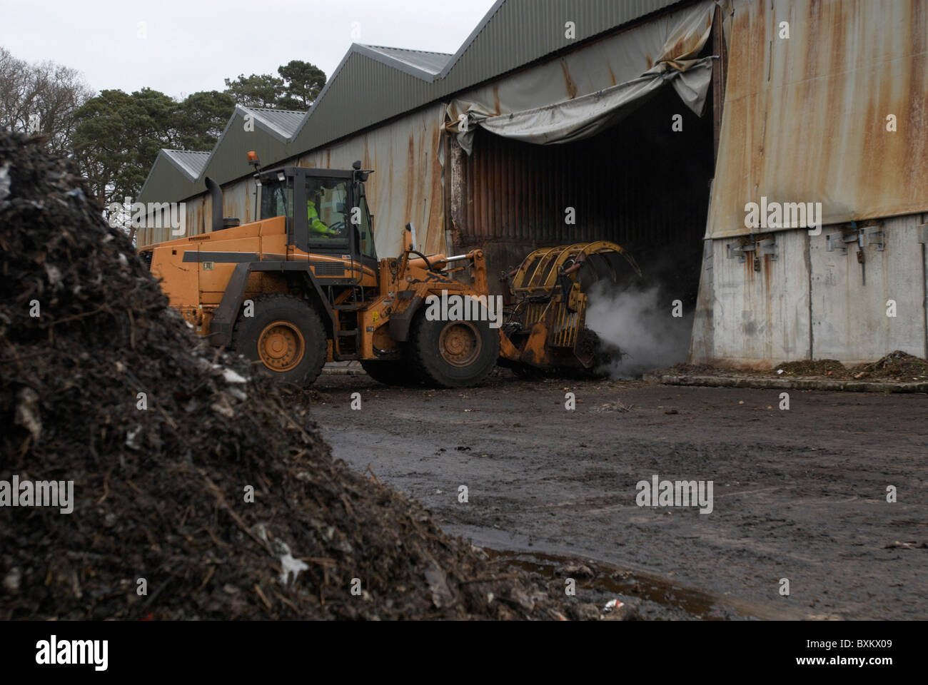 Front loader working at composting centre Stock Photo - Alamy