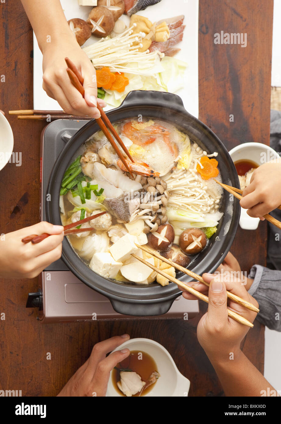 Parents and children eating Japanese nabe Stock Photo - Alamy