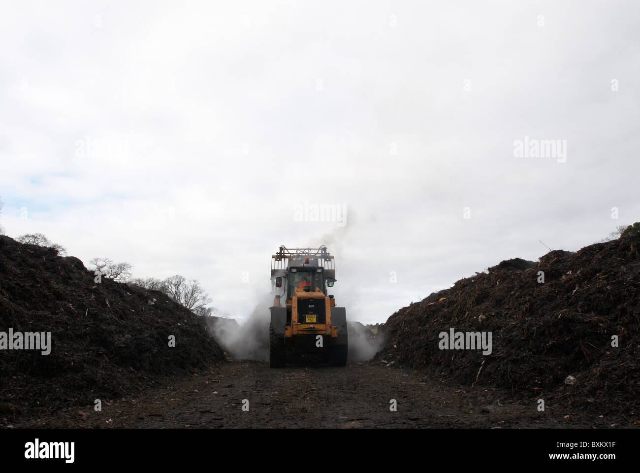 Front loader working at composting centre Stock Photo - Alamy