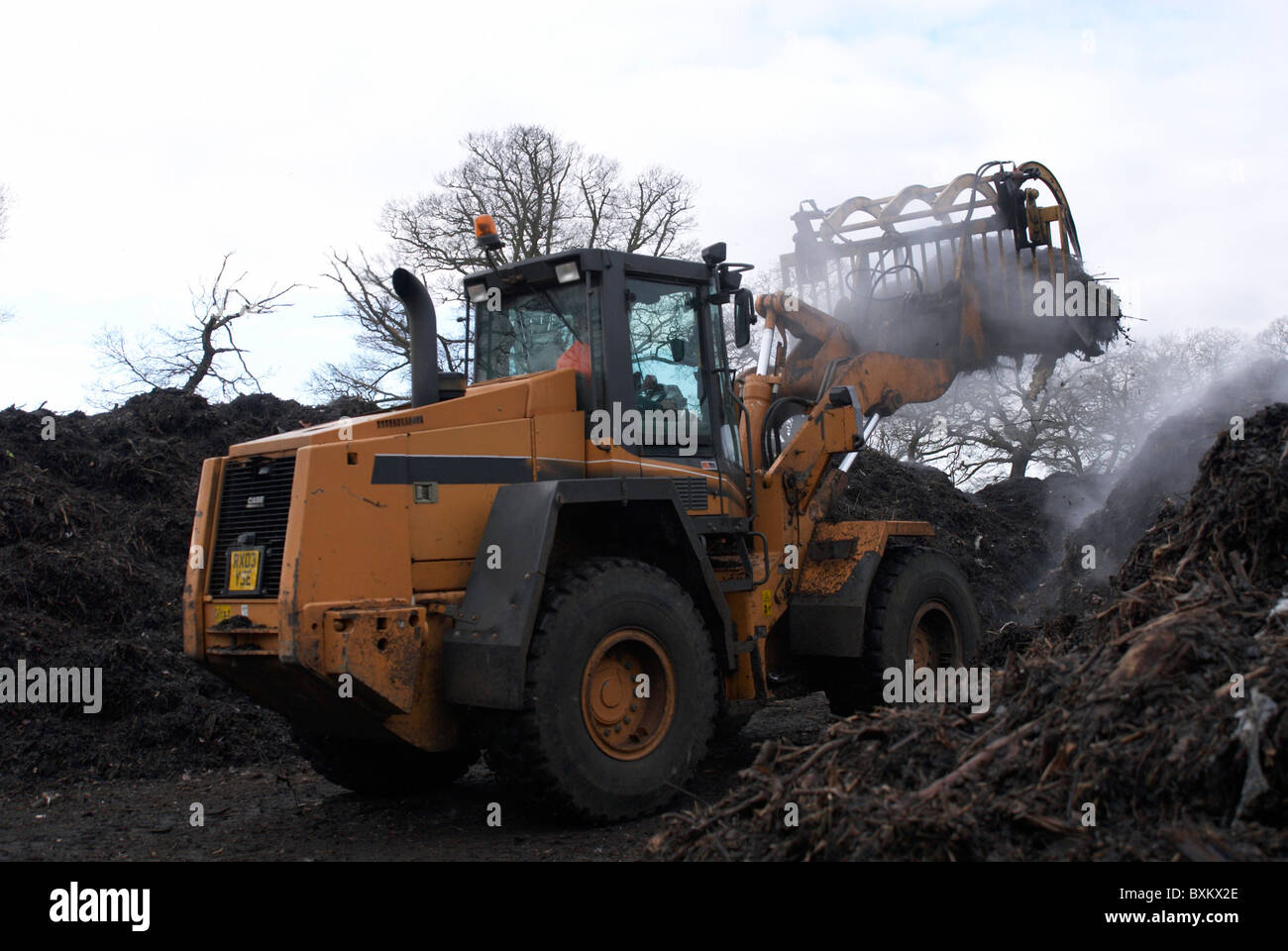 Front loader working at composting centre Stock Photo - Alamy