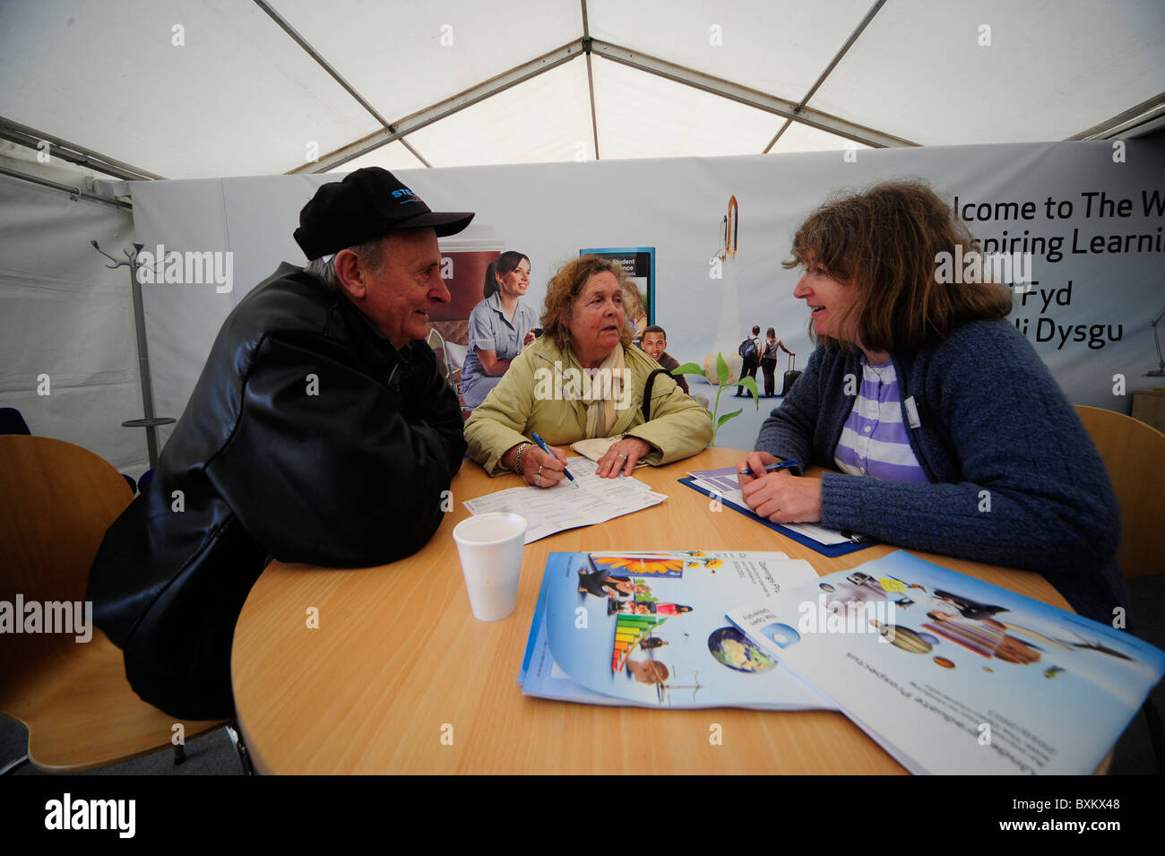 two people talk about further education to a teacher Stock Photo - Alamy