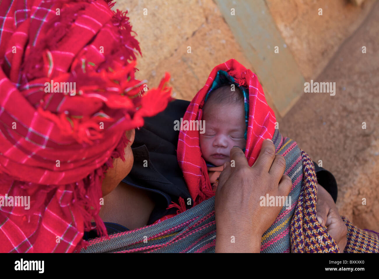 tribal young burmese baby and her mother arms Stock Photo - Alamy