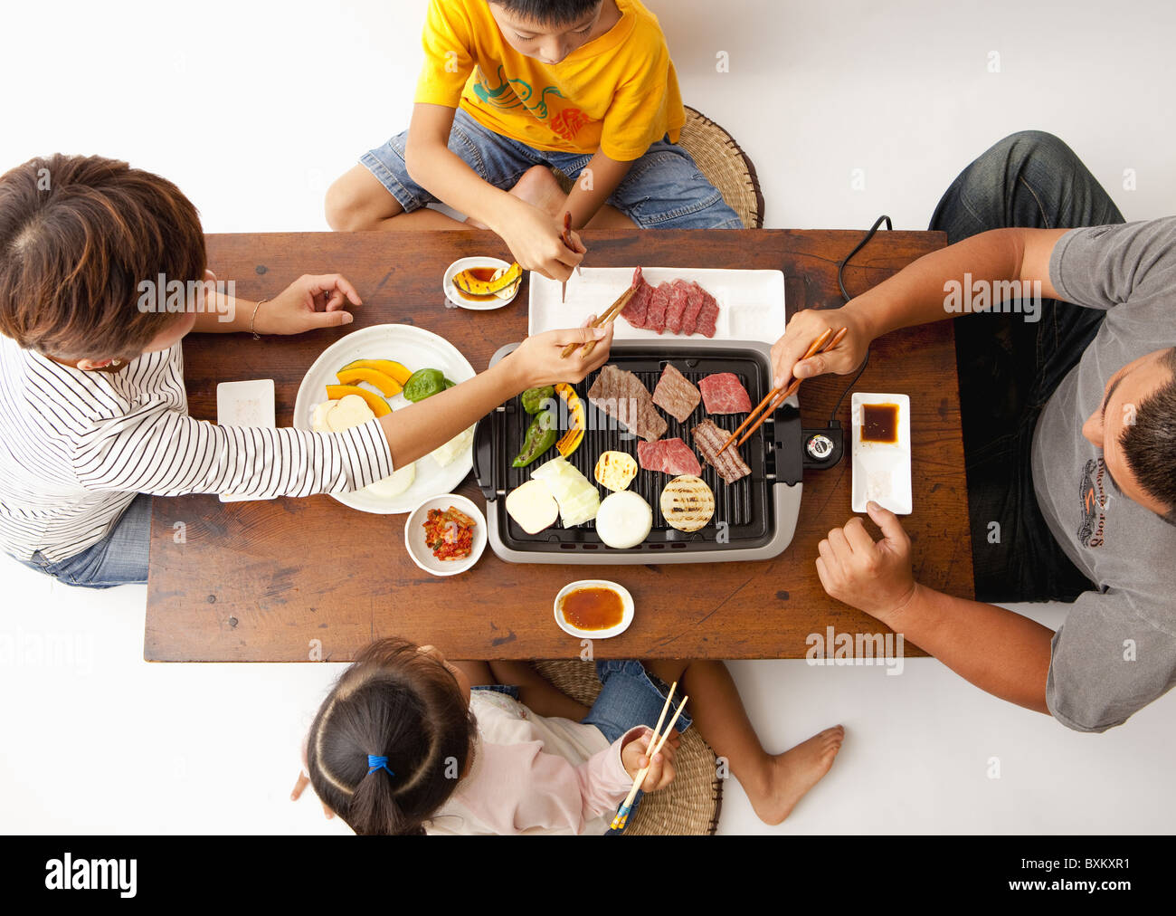 Parents and children taking a meal Stock Photo - Alamy