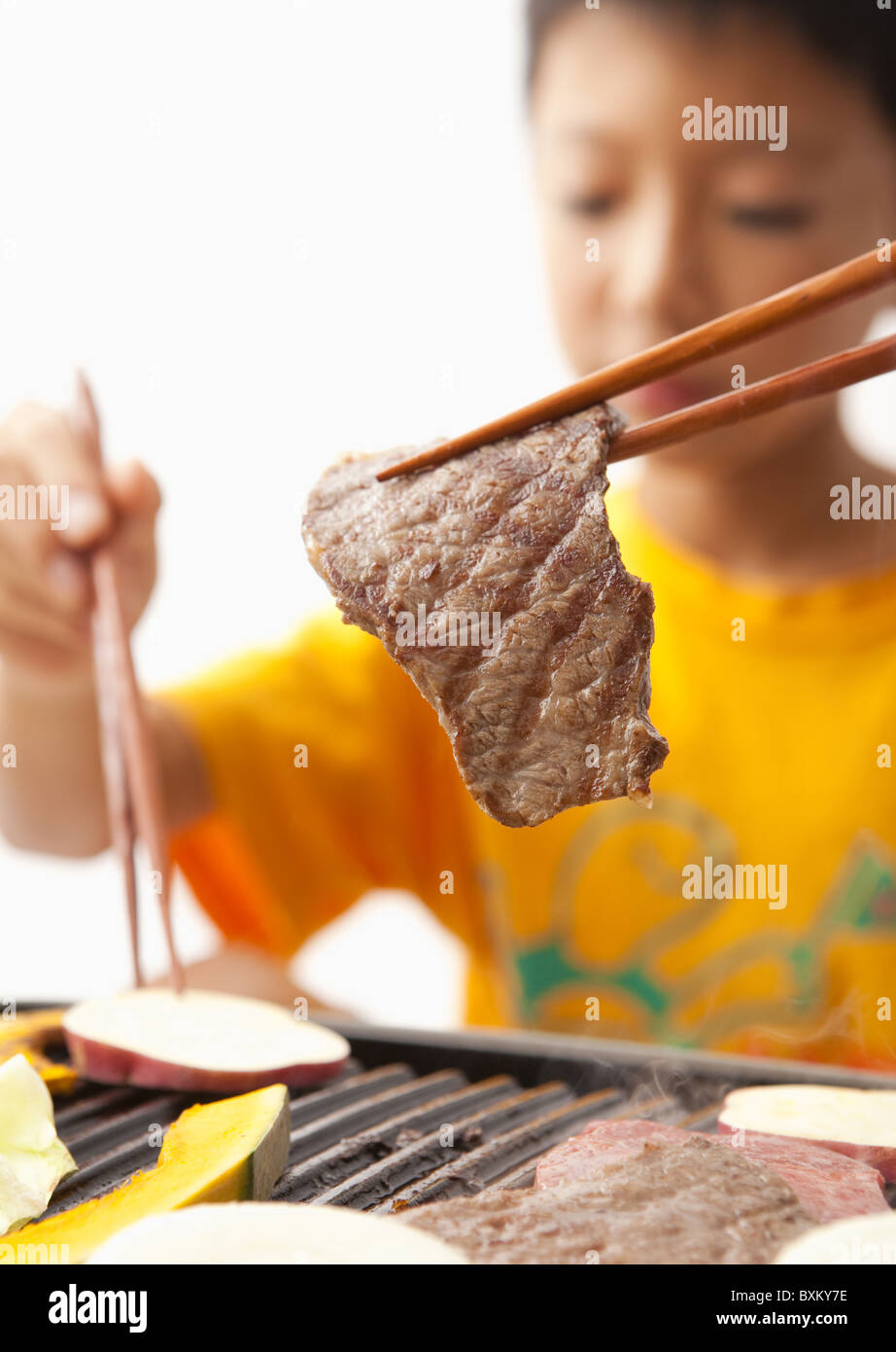 Parents and children eating korean barbecue Stock Photo - Alamy