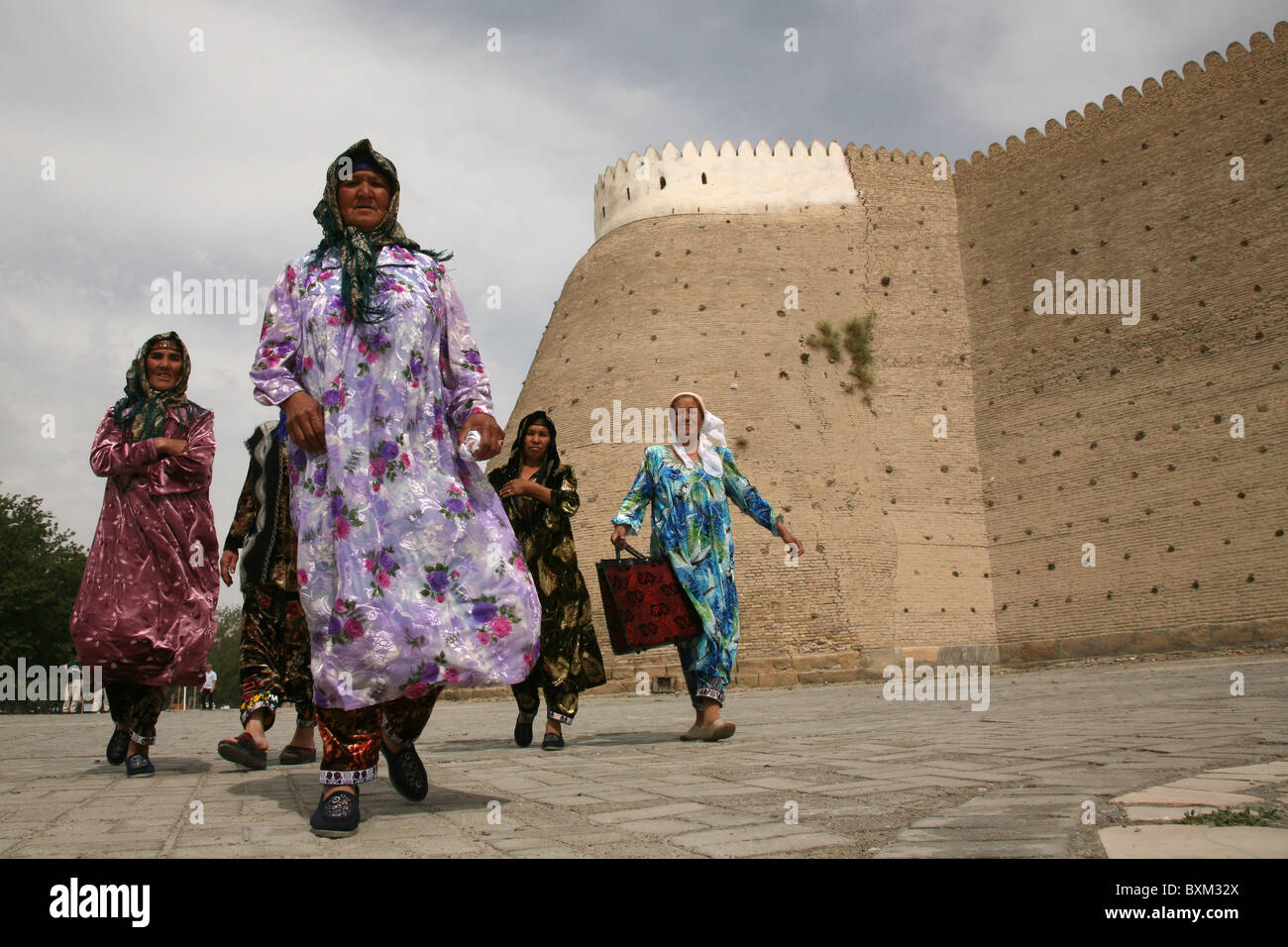 Uzbek women walking near the Ark Fortress, the residence of Bukhara ...