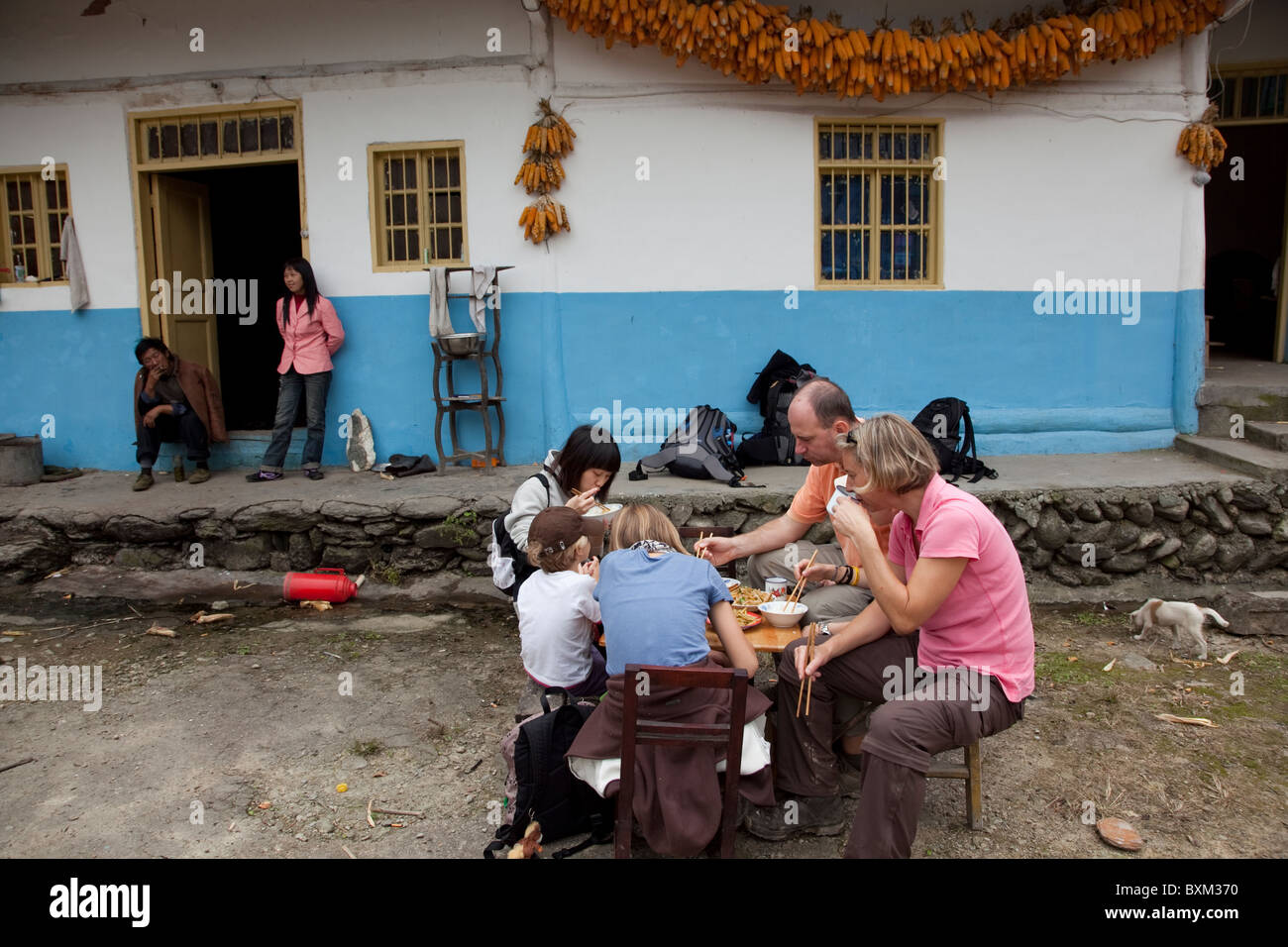 A group of trekkers having lunch prepared in a small isolated village ...