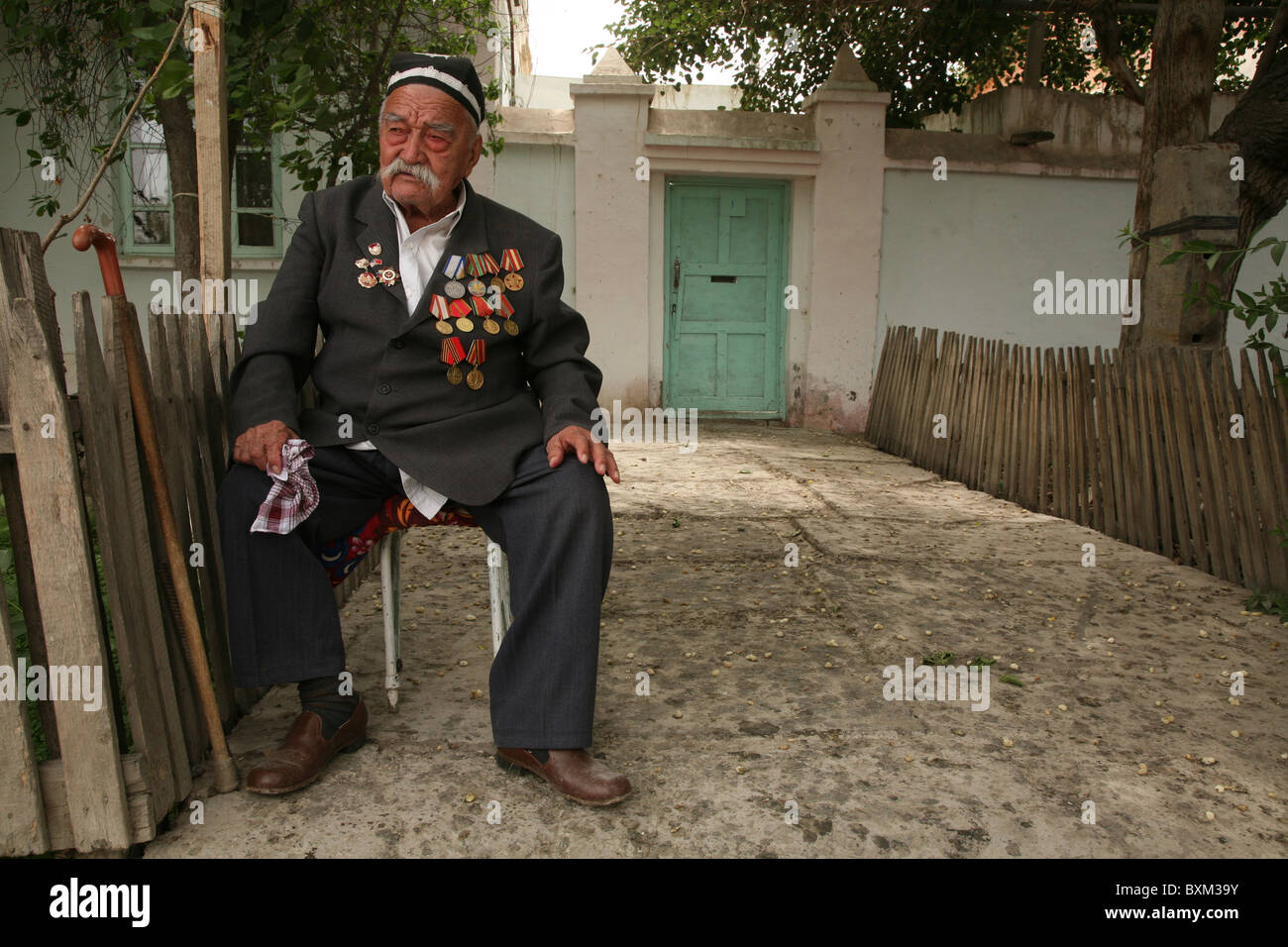 Second World War veteran sitting in front of his house in Bukhara, Uzbekistan Stock Photo - Alamy