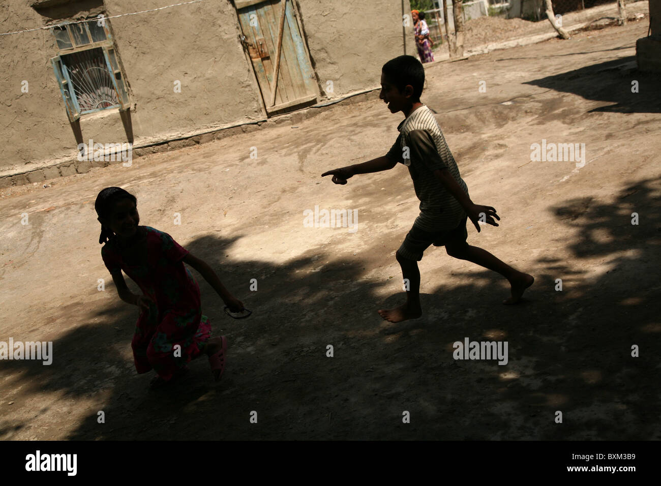 Children playing in the gypsy village of Gigikhana near Bukhara ...