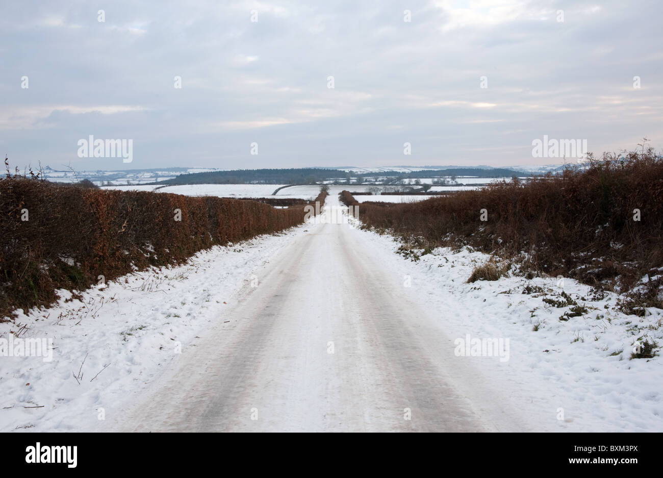 Untreated rural road covered in ice formed from frozen, compacted snow ...