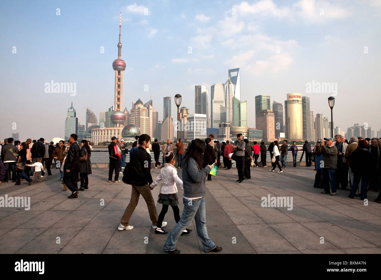 People standing at The Bund Promenade with view of Pudong in background ...