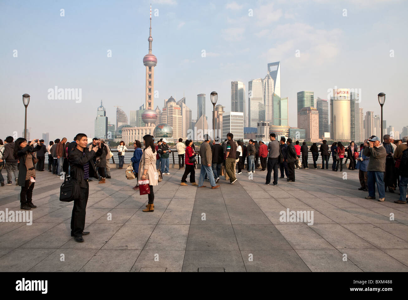 People standing at The Bund Promenade with view of Pudong in background ...