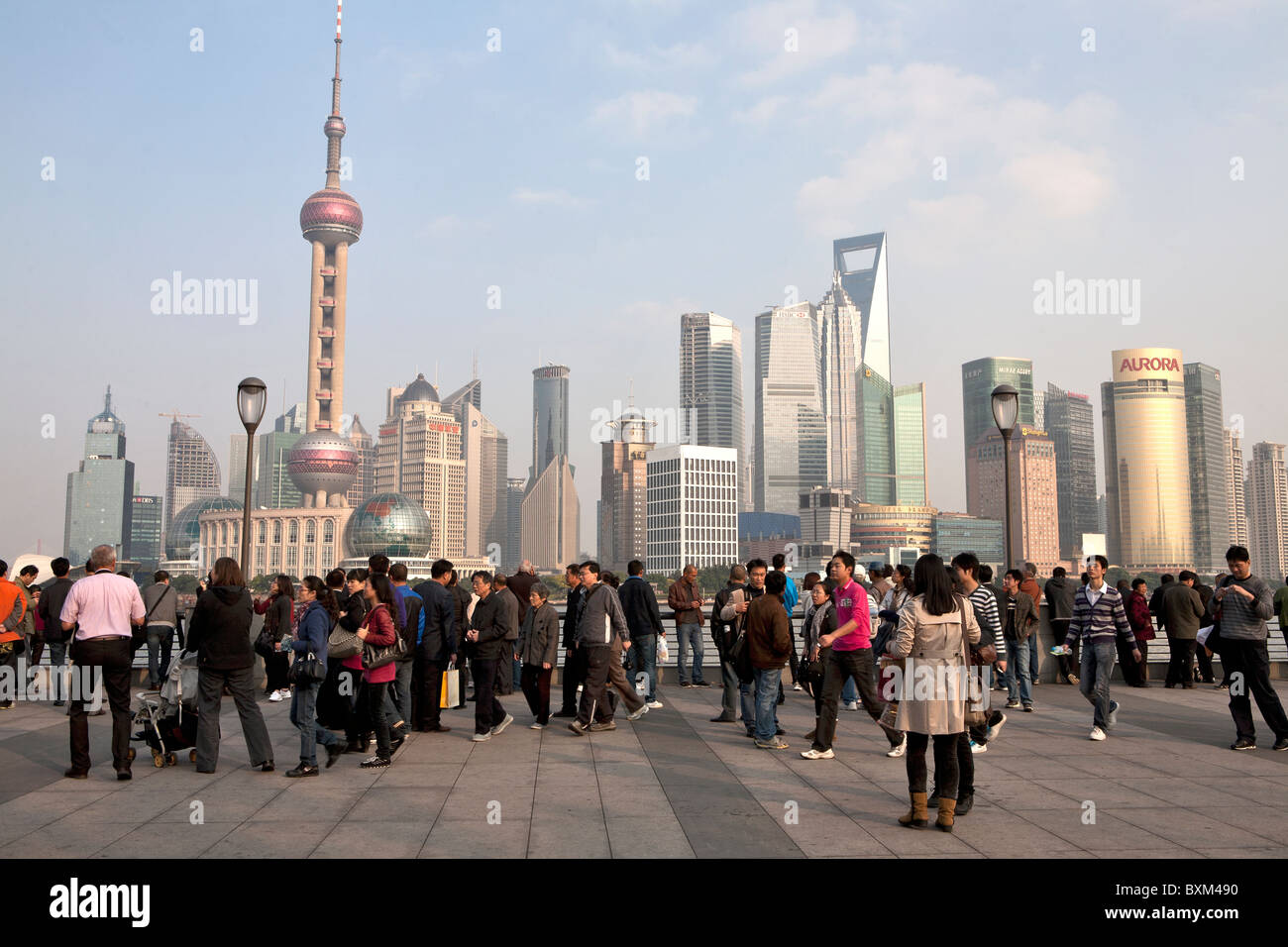 People standing at The Bund Promenade with view of Pudong onbackground ...