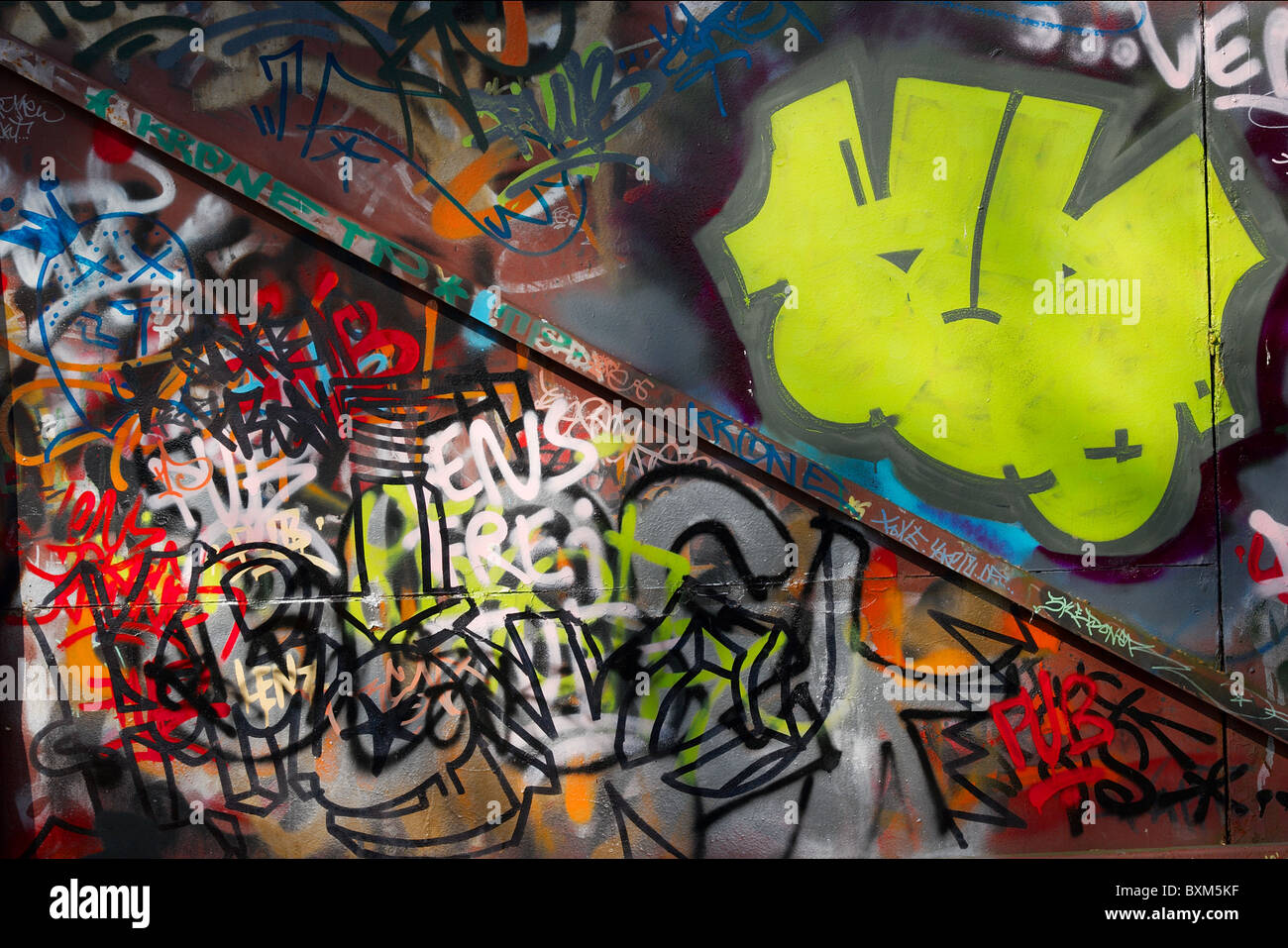 Old metal gate full of colorful graffiti Stock Photo - Alamy