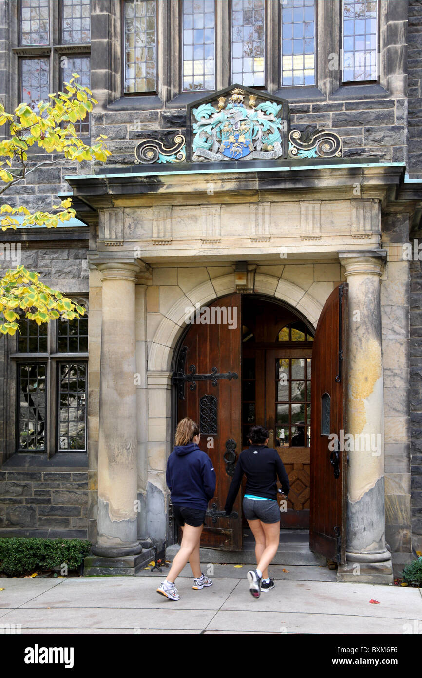 Students entering gothic style college building Stock Photo - Alamy