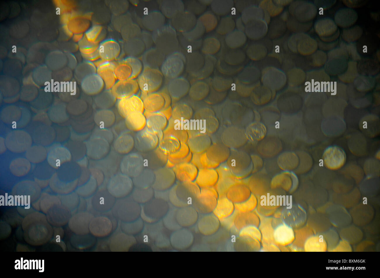 Streak of light over submerged coins, Gramado, Rio Grande do Sul ...