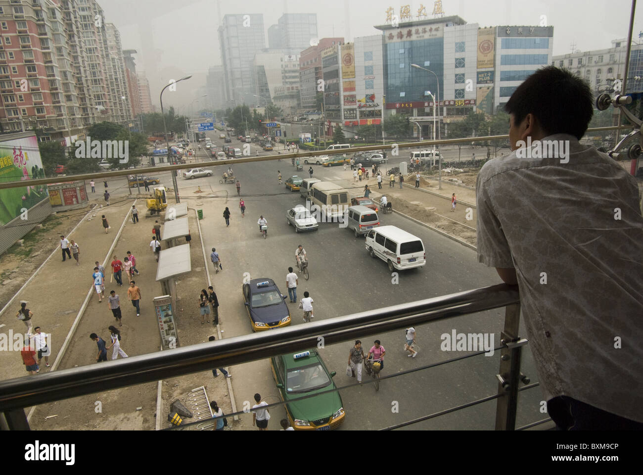 man looking over crowded street in beijing,china Stock Photo - Alamy