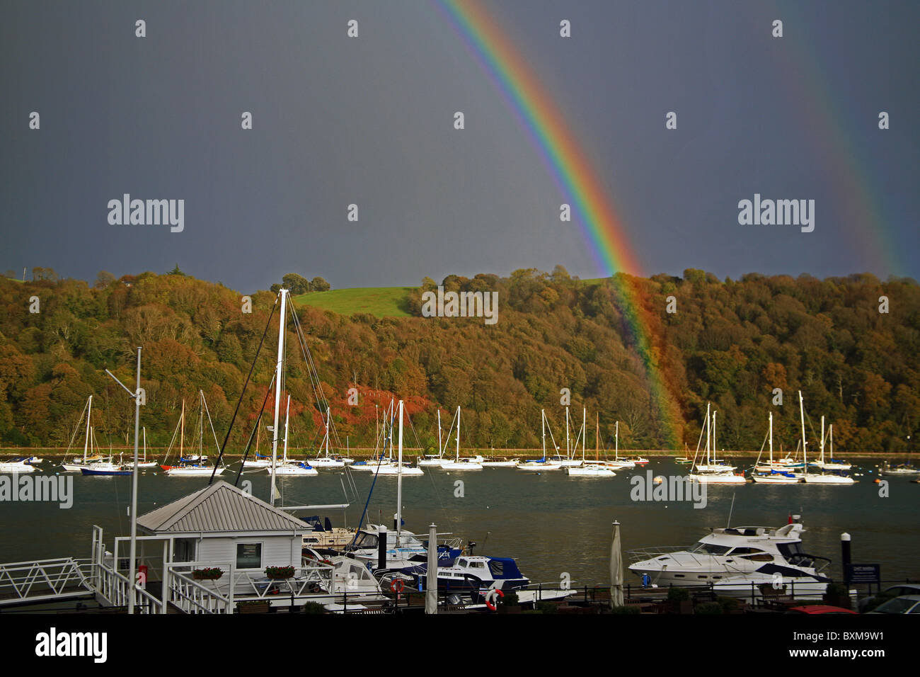 A rainbow over the yachts on the River Dart at Dartmouth, Devon ...