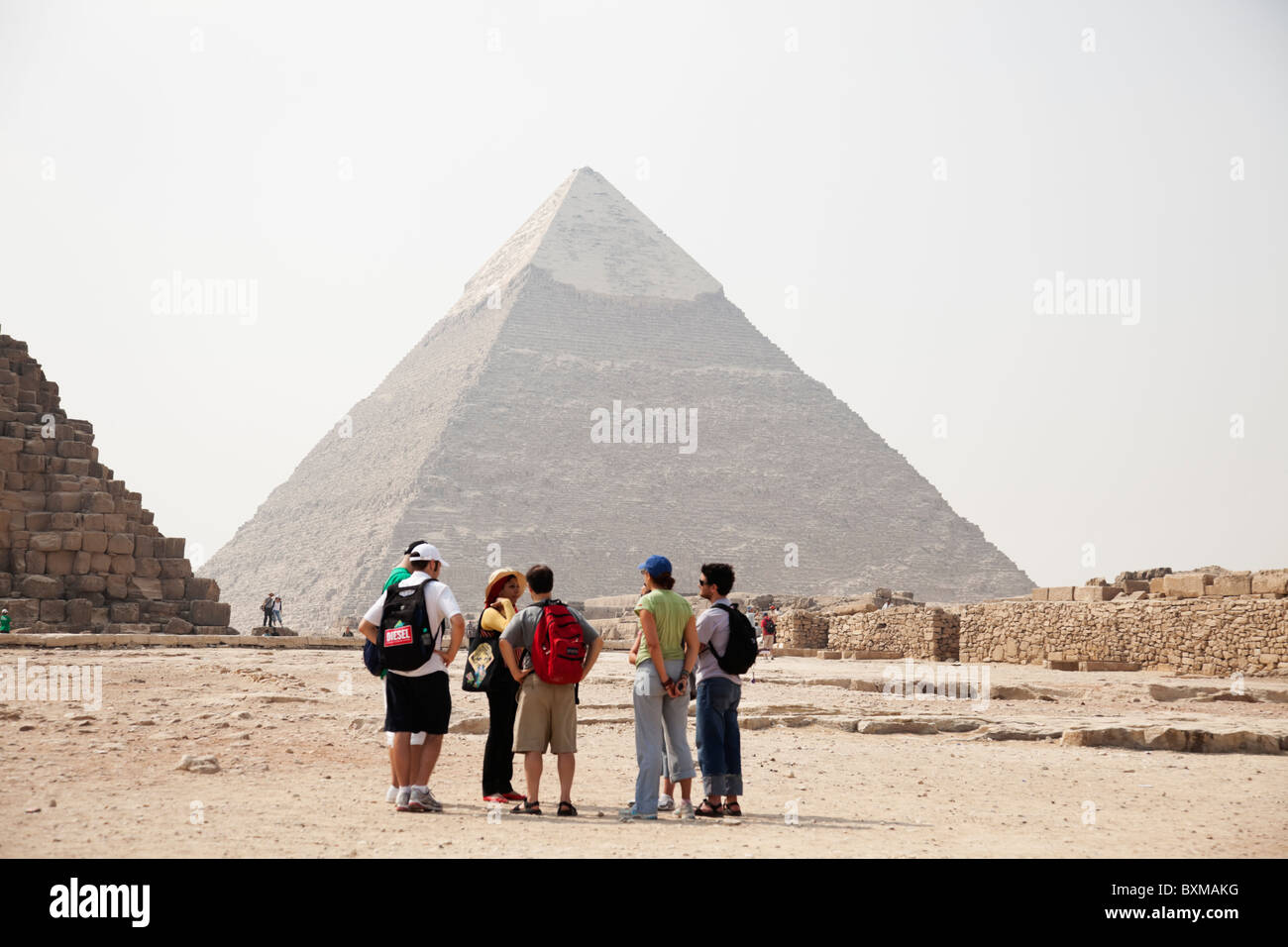Tourist guide explain the history of the pyramid to young tourists ...