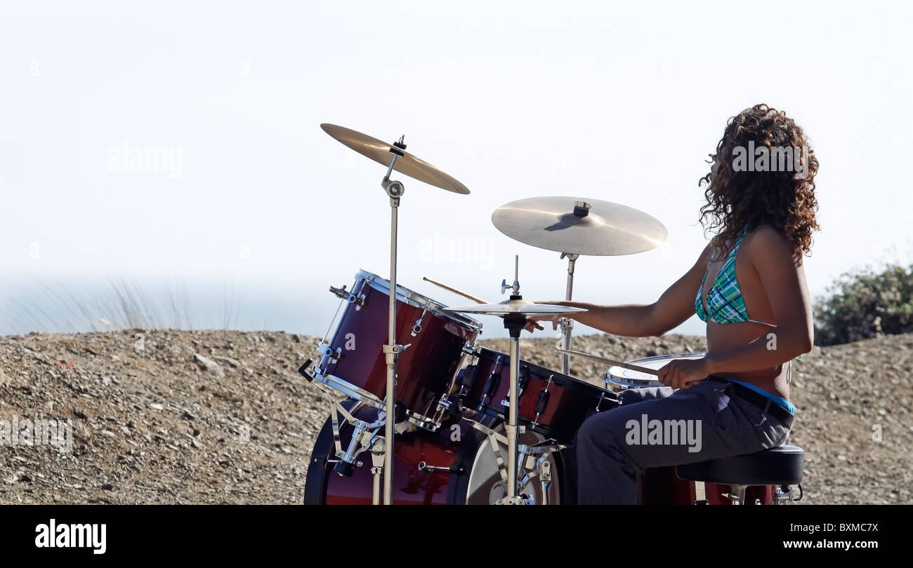 Female drummer practicing at the beach Stock Photo - Alamy