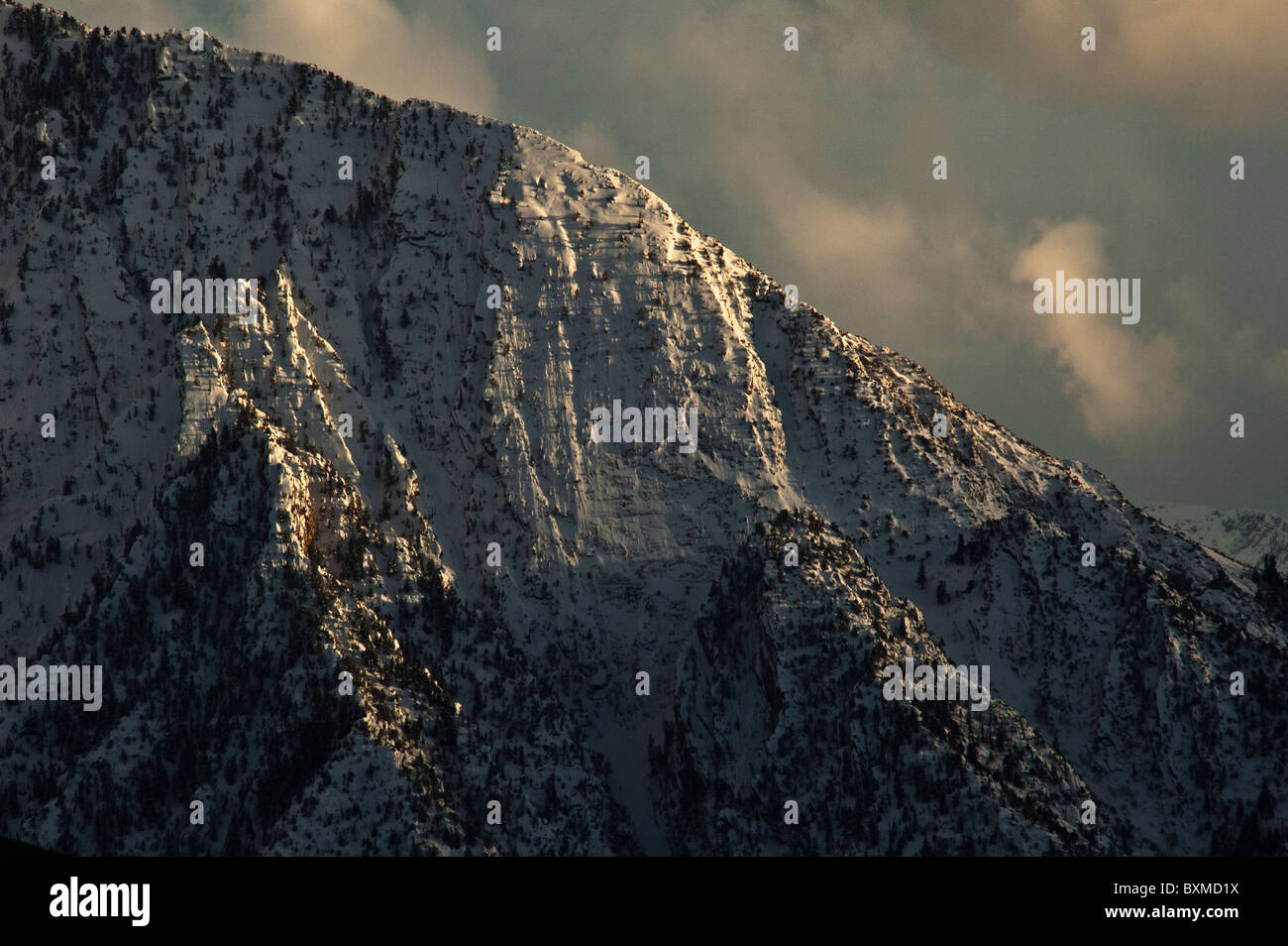 Sheer rock face covered with snow and ice in low light at dusk Stock ...