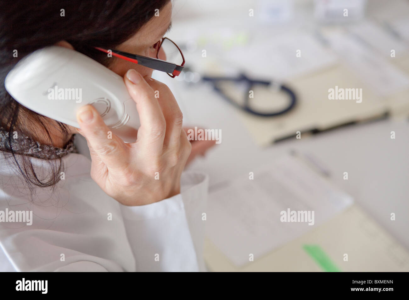 Female doctor consulting patients over the telephone Stock Photo - Alamy