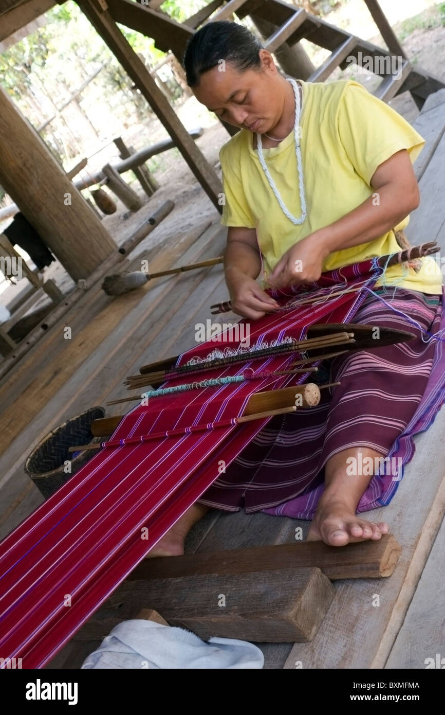 An ethnic Lahu woman is weaving colorful cloth by hand in Ban Mae Han ...