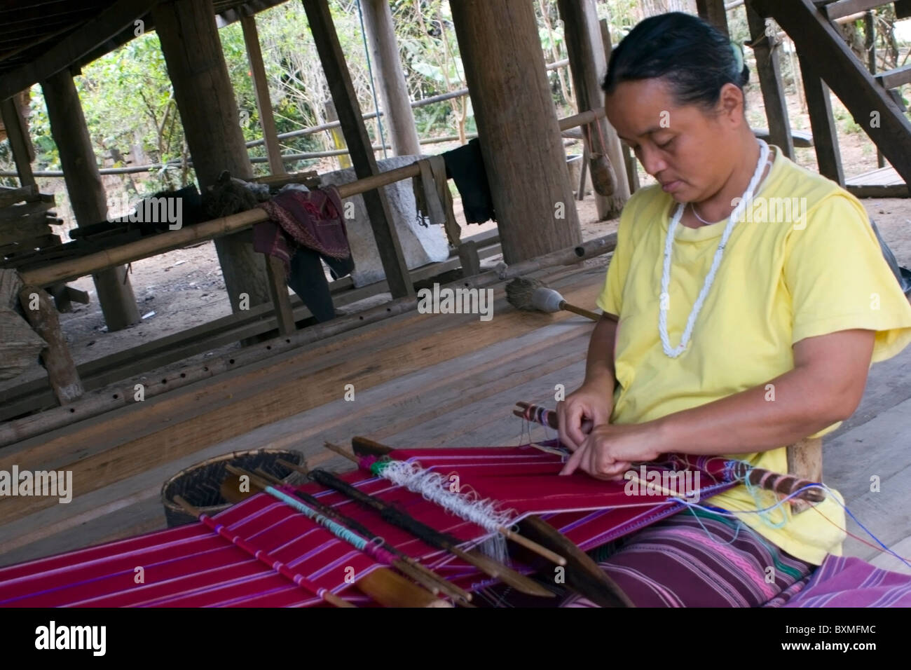 An ethnic Lahu woman is weaving colorful cloth by hand in Ban Mae Han ...