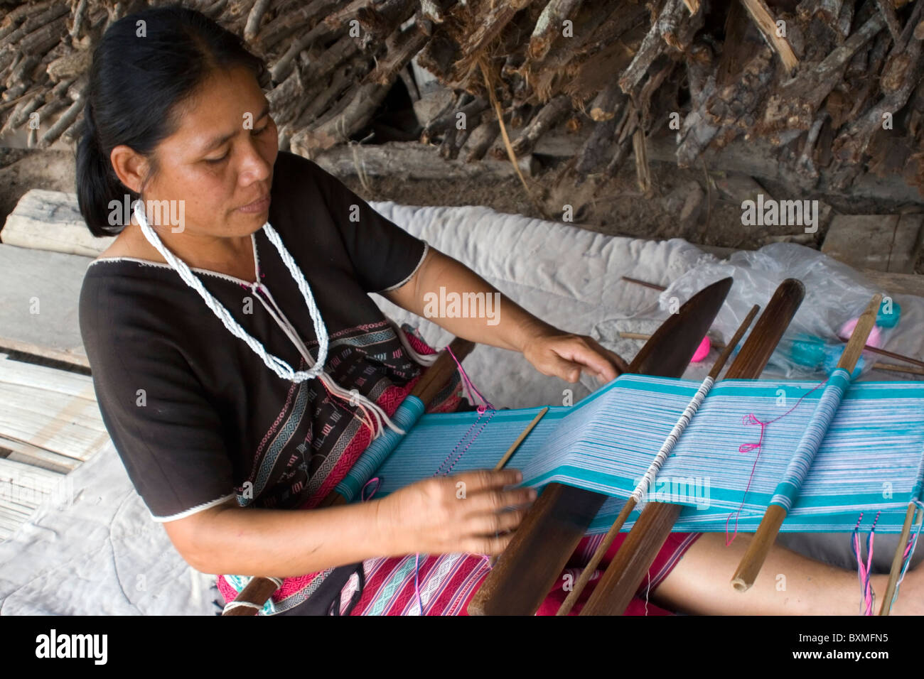 An ethnic Lahu woman is weaving colorful cloth by hand in Ban Mae Han ...