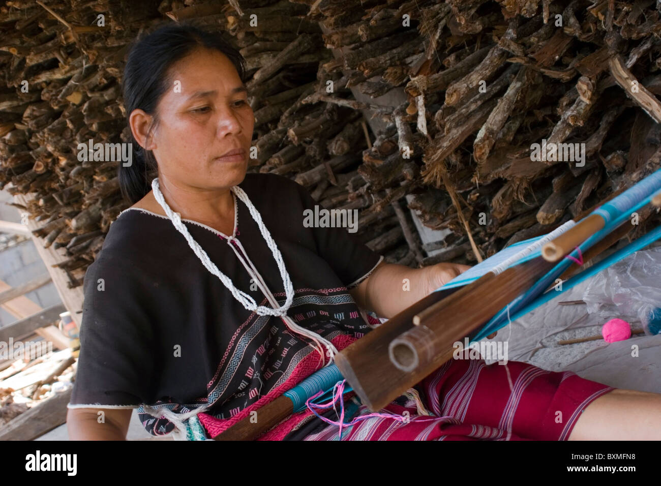 An ethnic Lahu woman is weaving colorful cloth by hand in Ban Mae Han ...