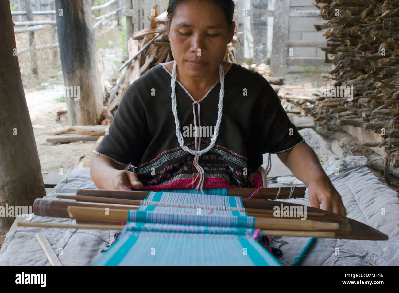 An ethnic Lahu woman is weaving colorful cloth by hand in Ban Mae Han ...