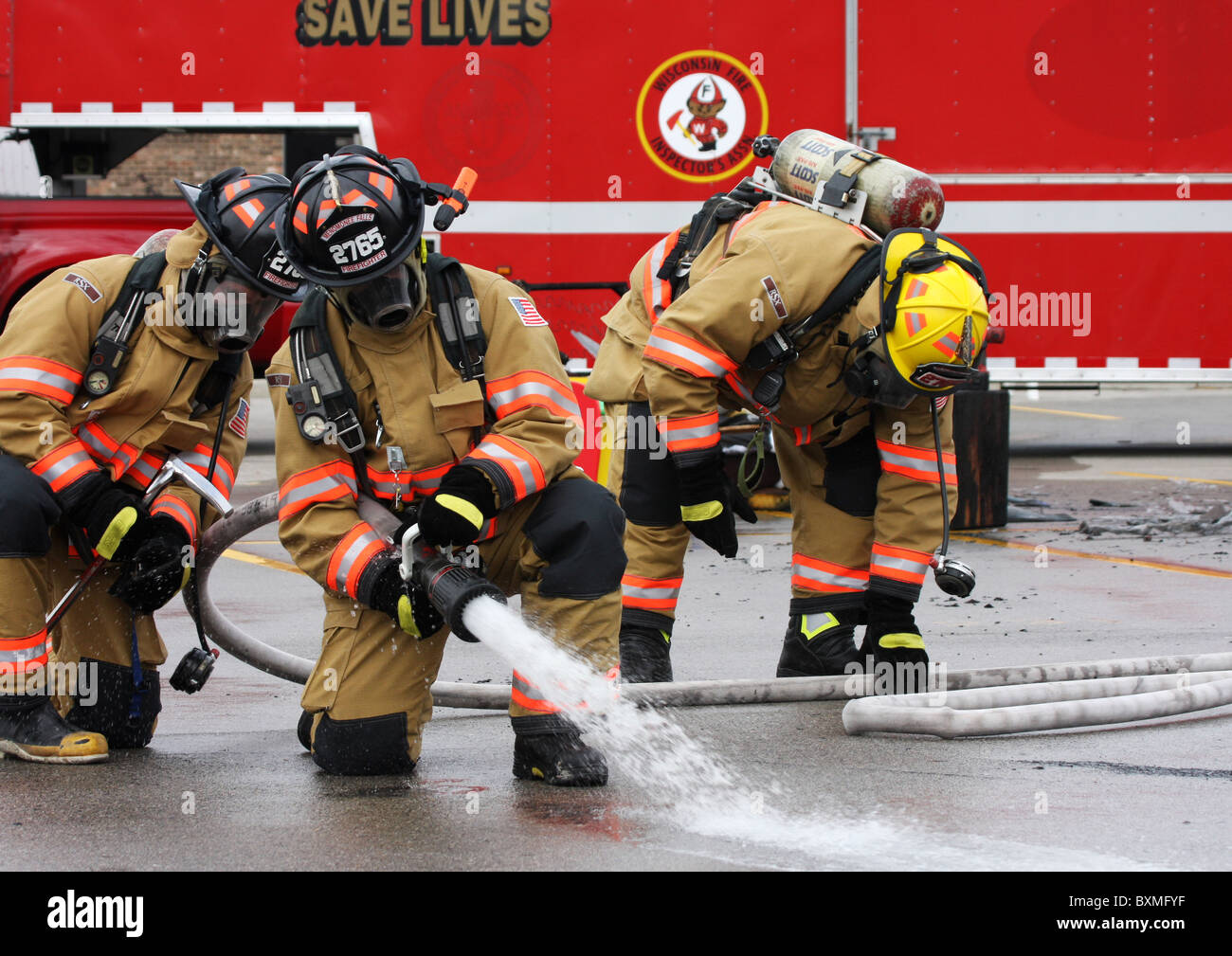 Firefighters on a hoseline fighting a fire saving lives Stock Photo - Alamy