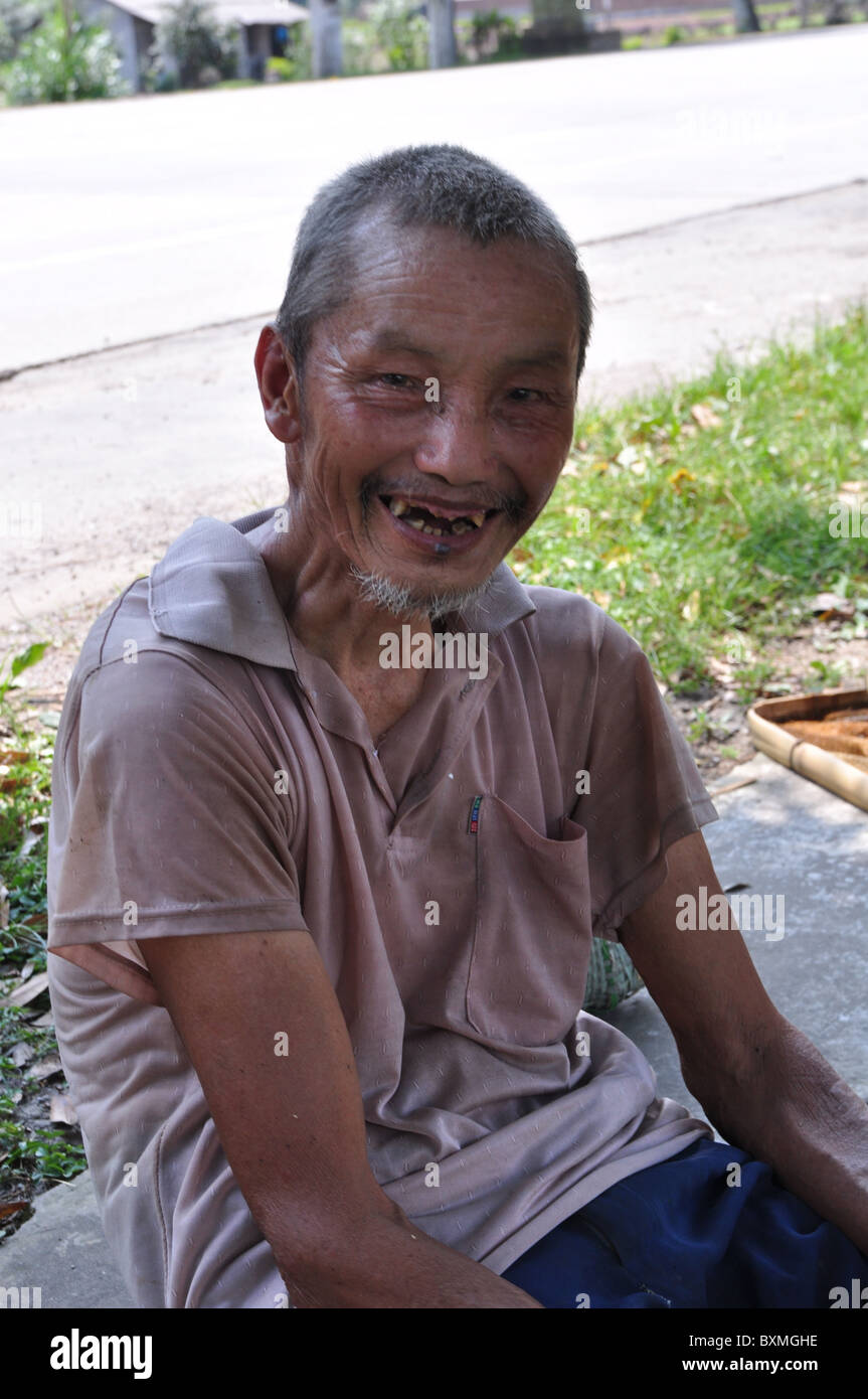 An old, happy man is resting under a tree in Guilin area, Southern ...