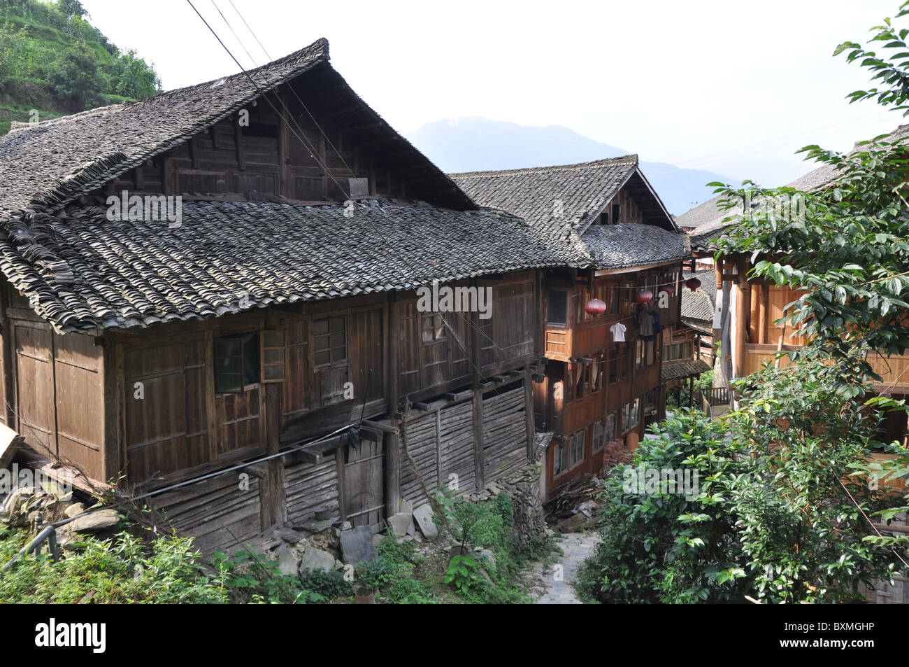 Wooden buildings in a stunning scenery at Longji Rice Terrace, Southern ...