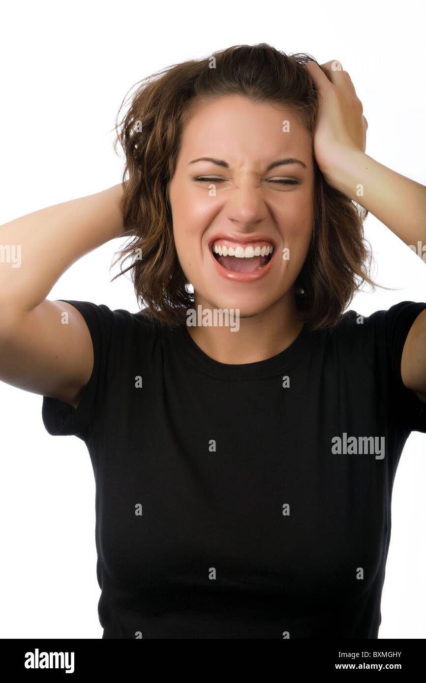 Young woman screaming while holding her head Stock Photo - Alamy