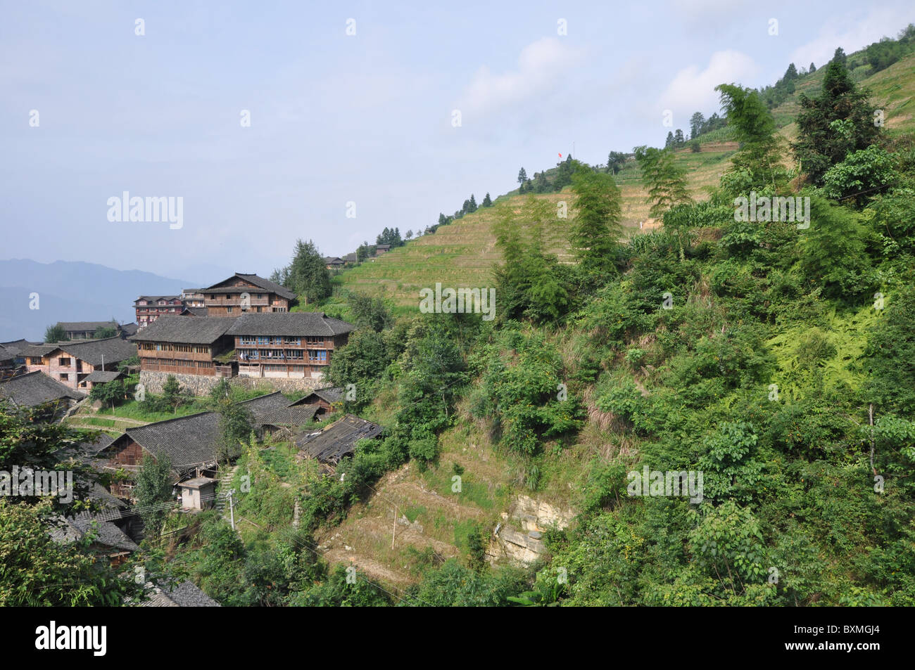 Wooden buildings in a stunning scenery at Longji Rice Terrace, Southern ...