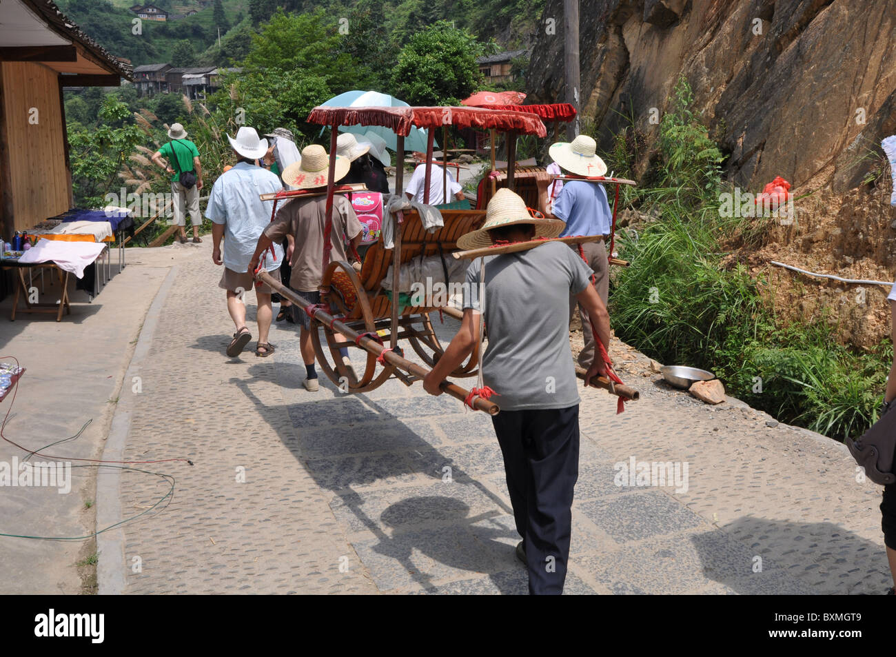 People on their way to the rice fields. They bring carriers with sedan ...