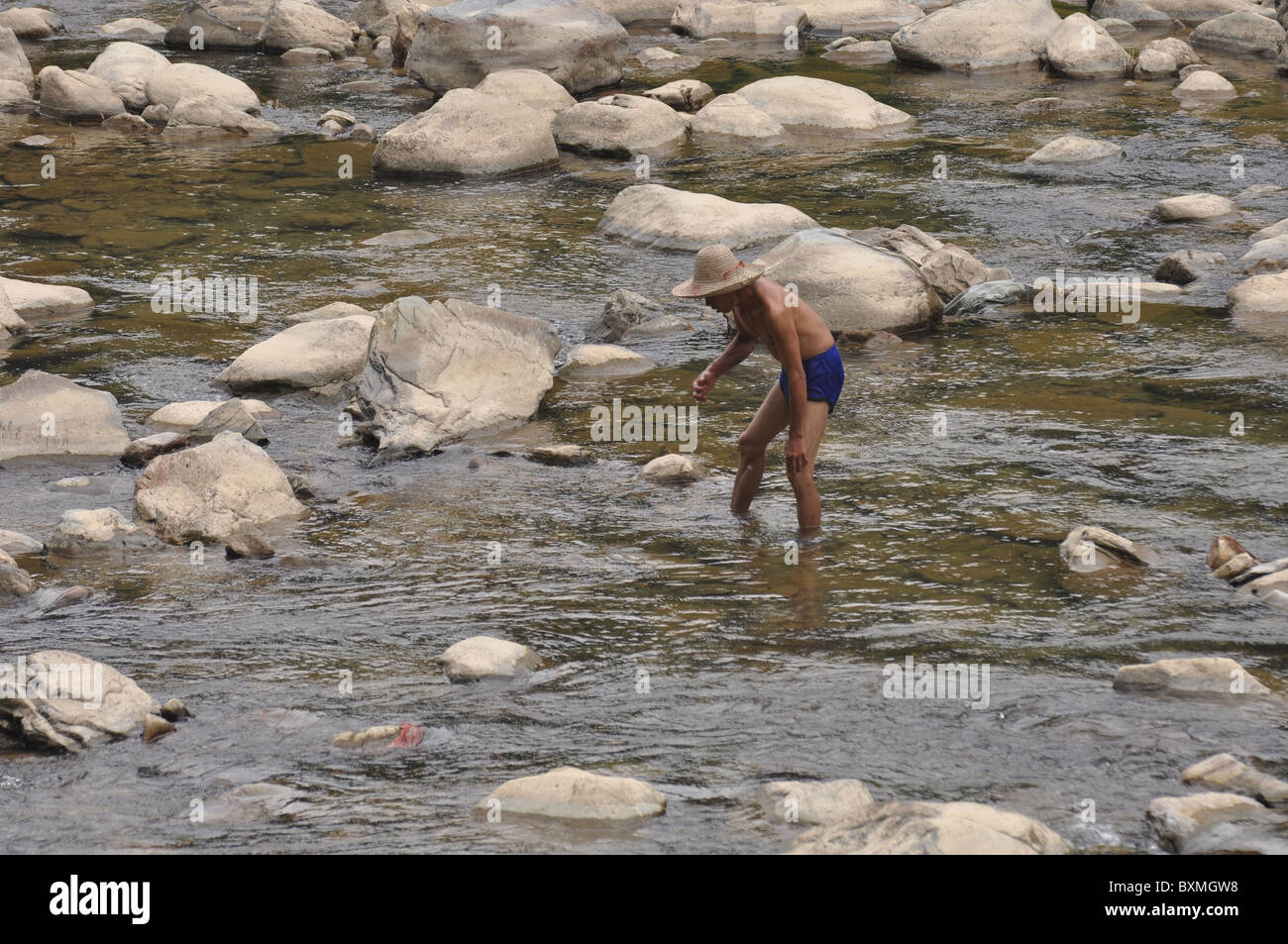 Chinese man fishing in a river in the Guilin area, Southern China Stock ...