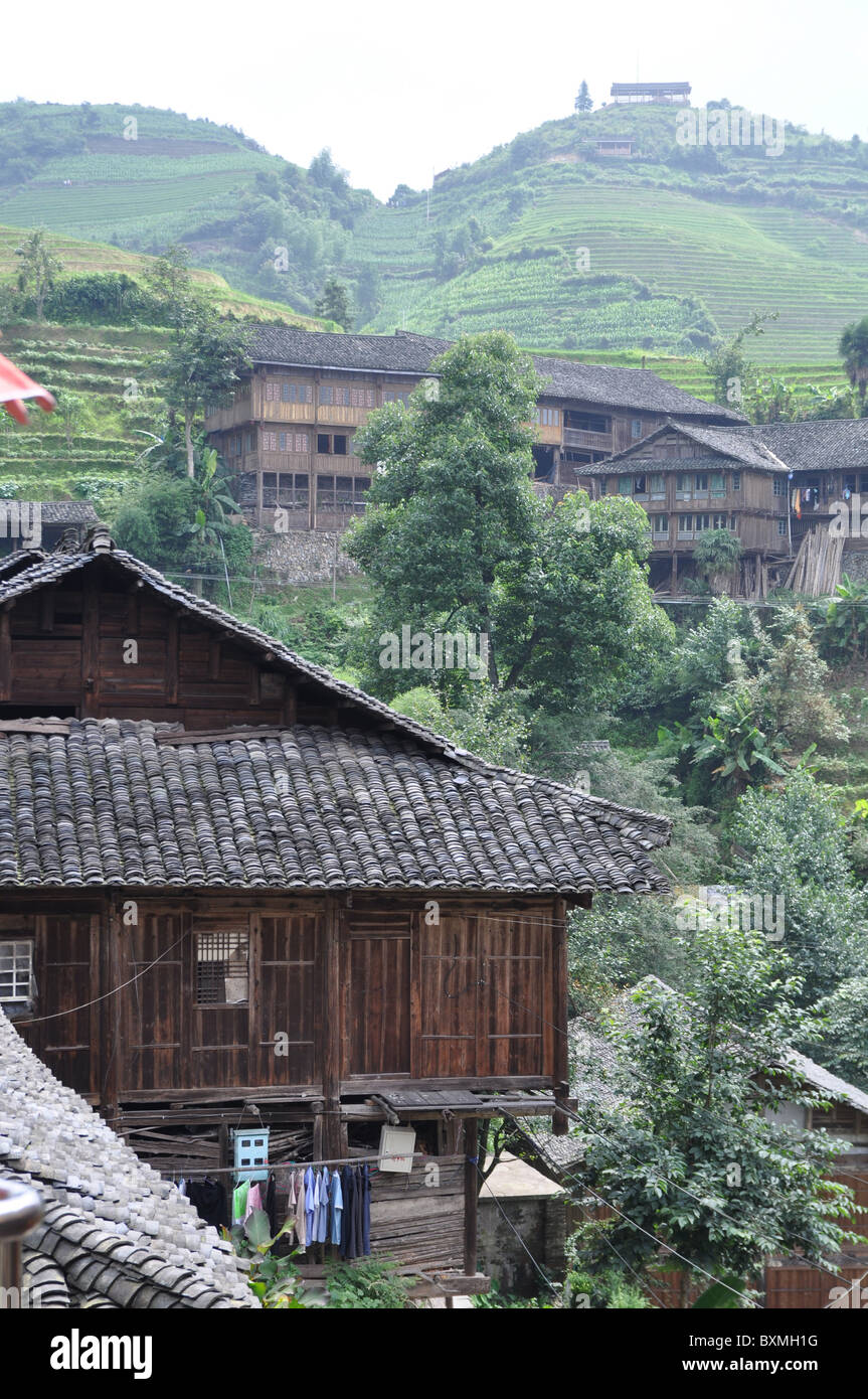 Wooden buildings in a stunning scenery at Longji Rice Terrace, Southern ...