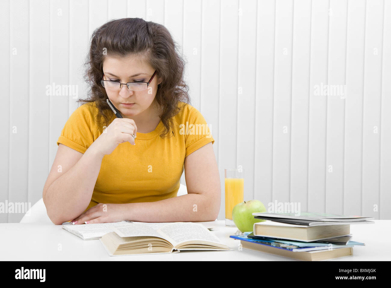 girl student sitting at a table in the classroom Stock Photo - Alamy